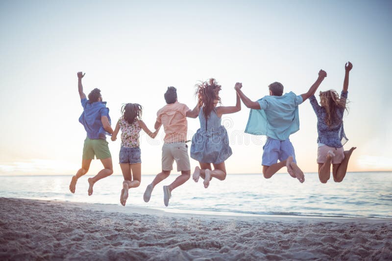 Happy Friends Holding Hands and Jumping Stock Photo - Image of jumping ...