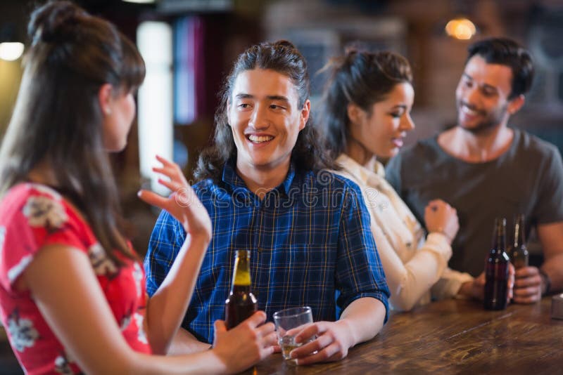 Happy Friends Interacting at Bar Counter Stock Image - Image of indoors ...