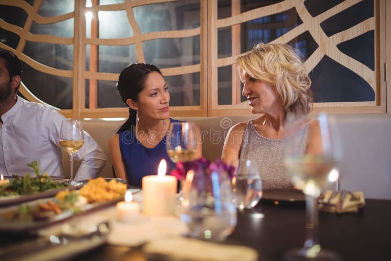 Happy Friends Interacting with Each Other while Having Dinner Stock ...