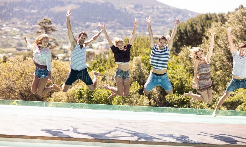 Happy friends jumping stock photo. Image of male, group - 66176162