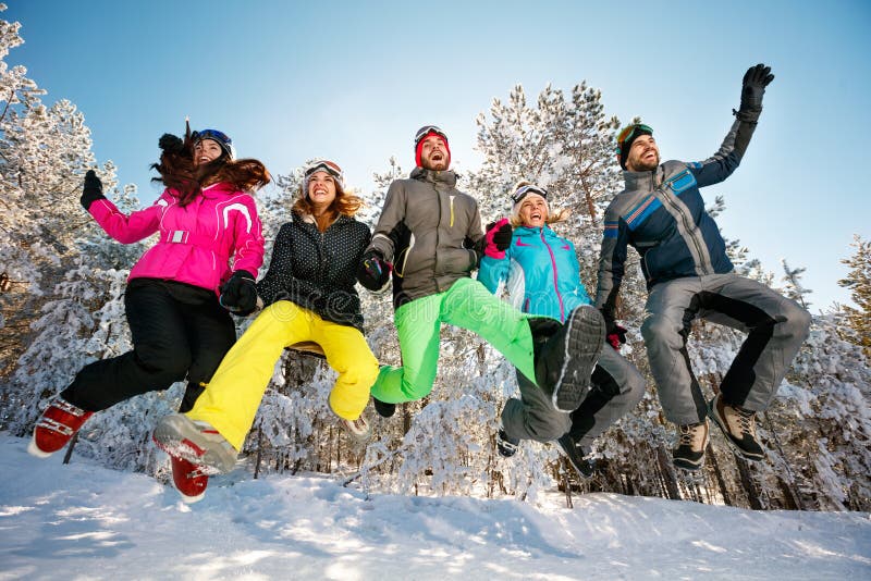 Happy Friends Jumping in the Snow Stock Photo - Image of forest ...