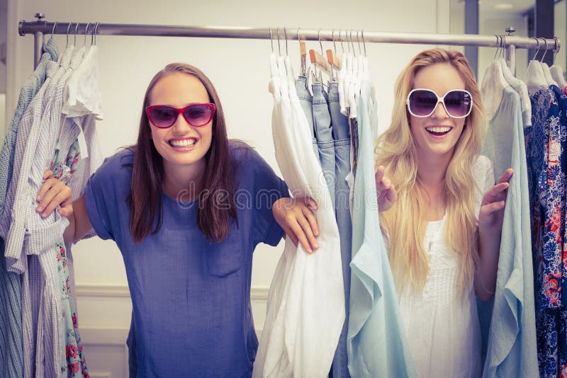Happy Friends Looking through the Clothes Rack Stock Image - Image of ...