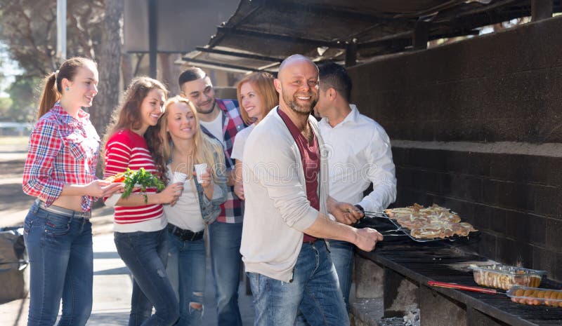 Happy friends making grill stock photo. Image of flame - 60369704