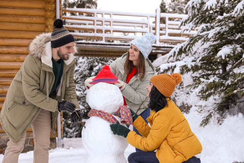 Happy Friends Making Snowman. Winter Vacation Stock Photo - Image of ...