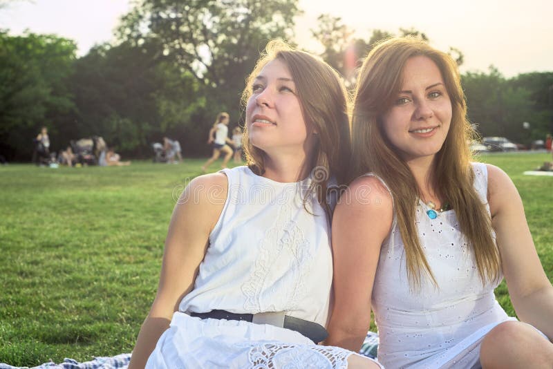 Happy friends in the park stock photo. Image of attractive - 76623358