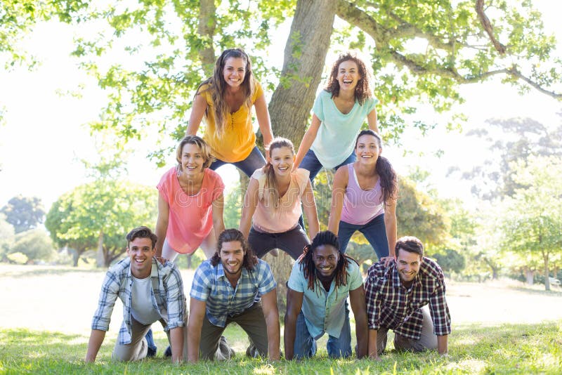 Happy Friends in the Park Making Human Pyramid Stock Image - Image of ...