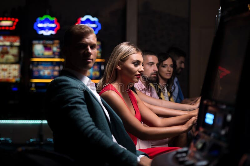 Happy Friends Playing Arcade Machine in a Casino Stock Photo - Image of ...