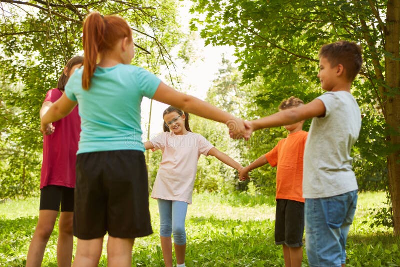 Happy Friends Playing Ring-around-the-rosy at Park Stock Image - Image ...