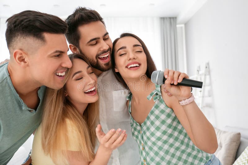 Happy Friends Singing Karaoke Together at Home Stock Photo - Image of ...