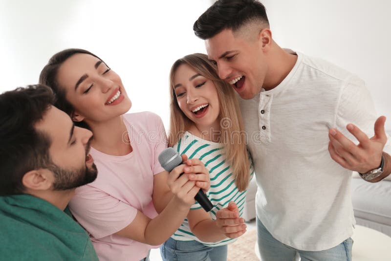 Happy Friends Singing Karaoke Together at Home Stock Photo - Image of ...