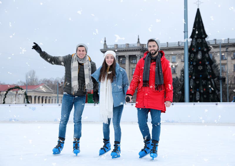 Happy Friends Skating Along Ice Rink Outdoors Stock Photo - Image of ...