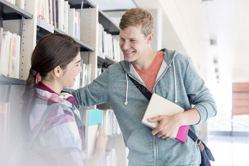 Happy Friends Talking in Library at College Stock Photo - Image of ...