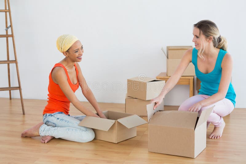 Happy Friends Unwrapping Boxes in a New House Stock Image - Image of ...