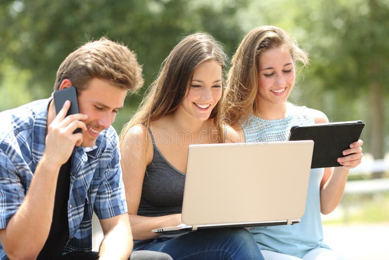Happy Friends Using Multiple Devices on a Bench Stock Image - Image of ...