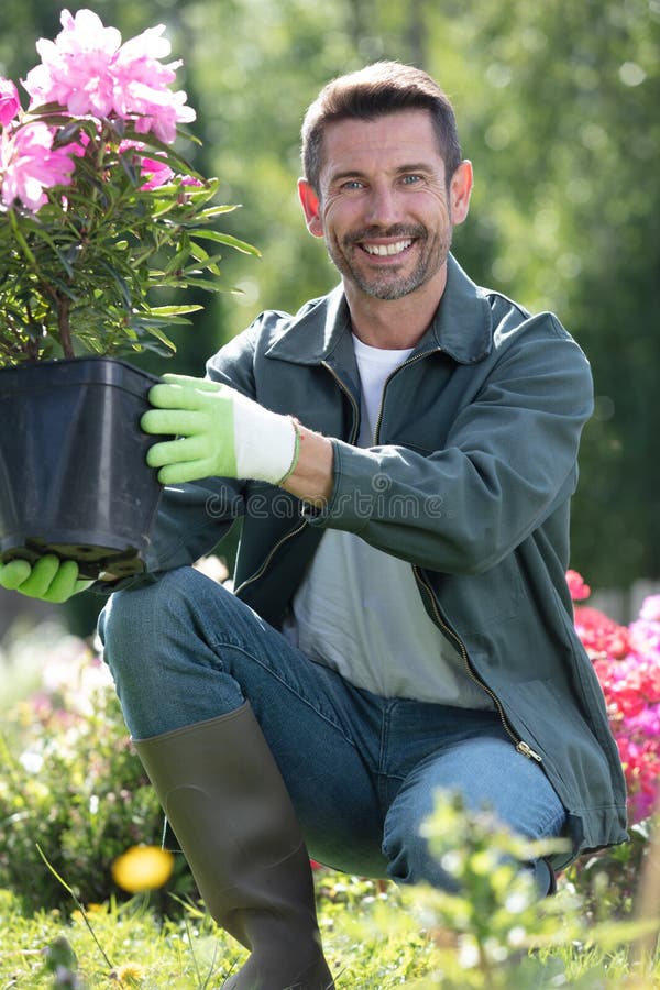 Happy Gardener Holding Flowers and Smiling Stock Photo - Image of ...