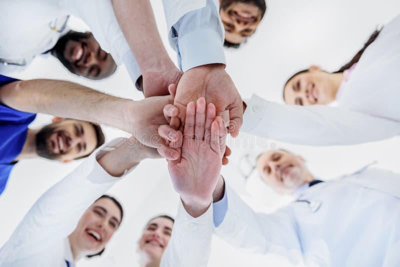 Happy General Practitioners Putting Arms Together Stock Image - Image ...