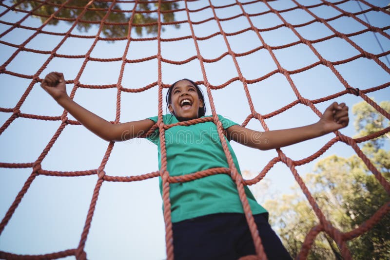 Happy Girl Cheering while Climbing a Net during Obstacle Course Stock ...