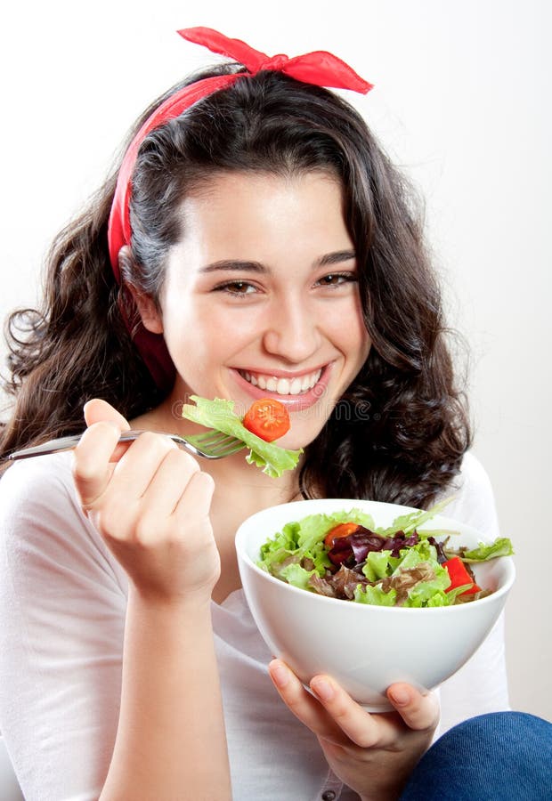 Happy girl eating salad stock photo. Image of brunette - 28813012