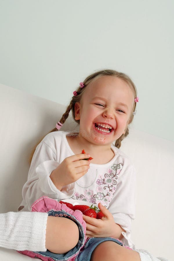 Happy Girl Eating Strawberry Stock Image - Image of child, smiling: 1959127