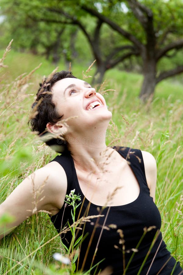 Happy girl on green field stock image. Image of female - 25202753