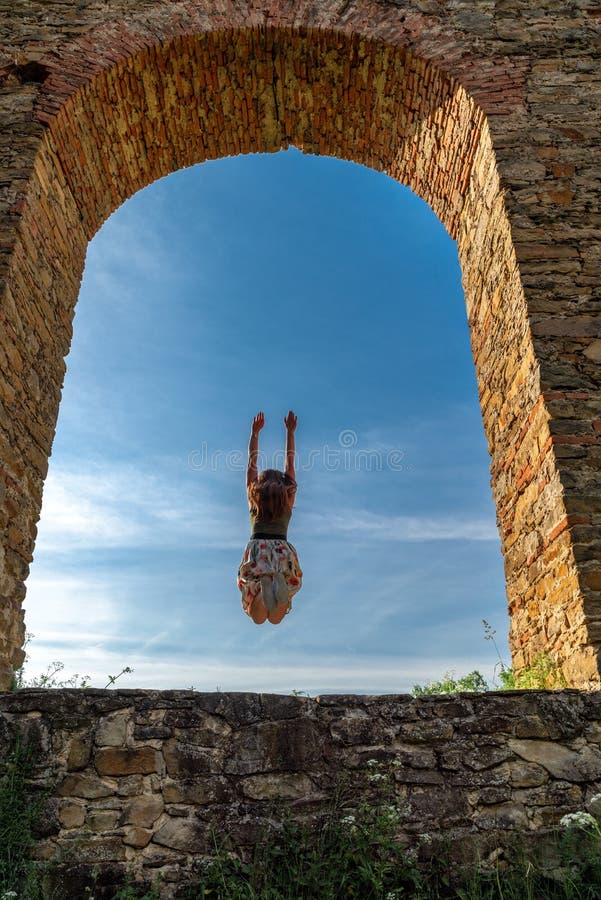Happy Girl Jumping in Large Window and Blue Sky at Background Stock ...