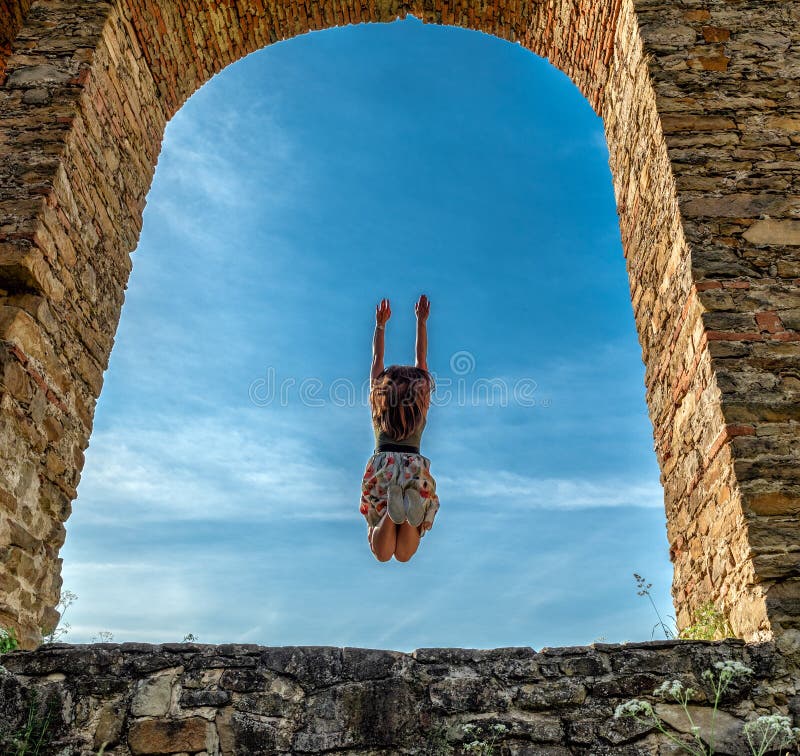 Happy Girl Jumping in Large Window and Blue Sky at Background Stock ...