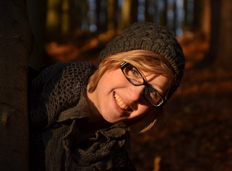 Happy Girl Looking Behind the Tree Stock Photo - Image of blonde ...