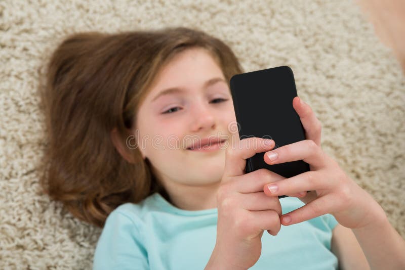 Happy Girl with Mobile Phone Stock Photo - Image of happiness, lying ...