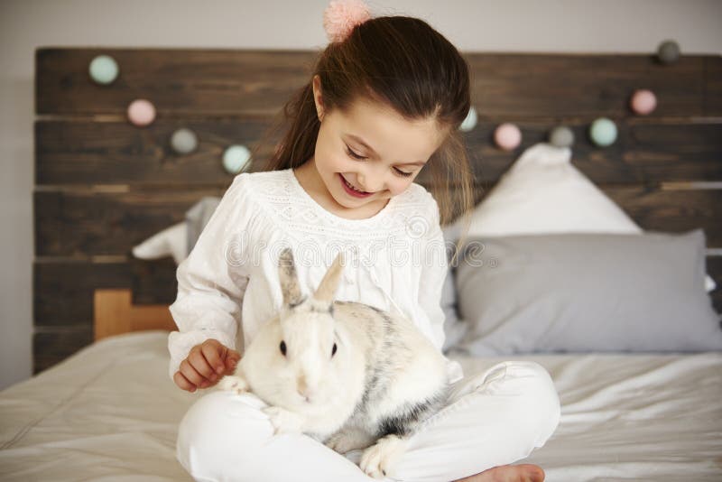 Happy Girl and Rabbit in Bedroom Stock Photo - Image of bedding ...