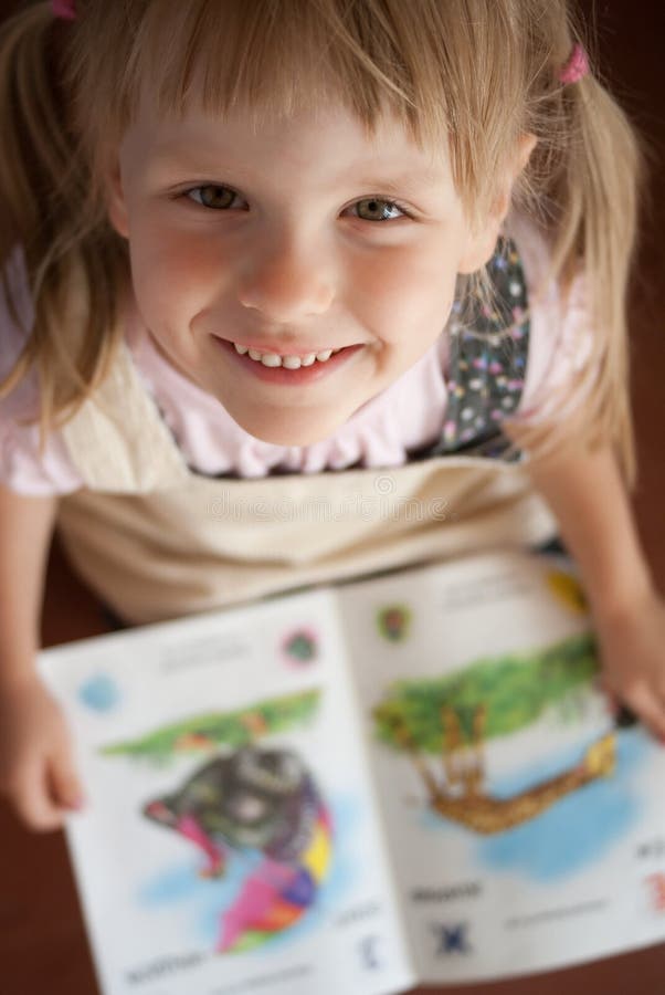 Happy girl reading book stock photo. Image of educational - 22541490