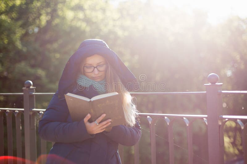 Happy Girl Reading a Book at the Railing. Stock Photo - Image of school ...
