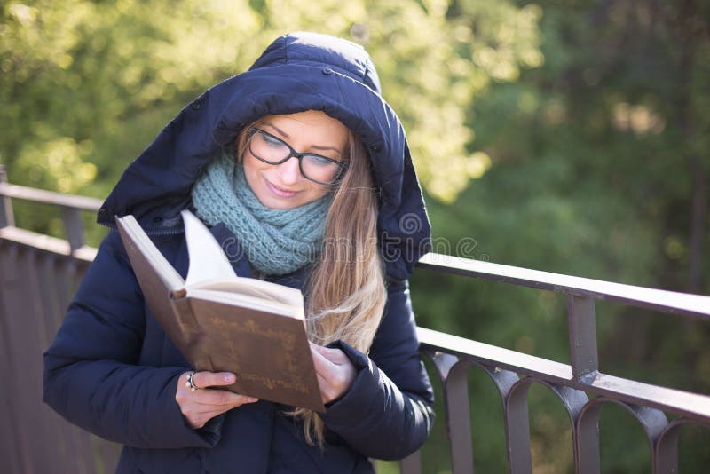 Happy Girl Reading a Book at the Railing. Stock Photo - Image of books ...