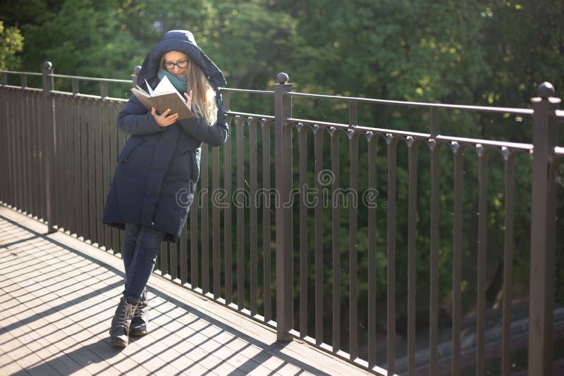 Happy Girl Reading a Book at the Railing. Stock Image - Image of alone ...