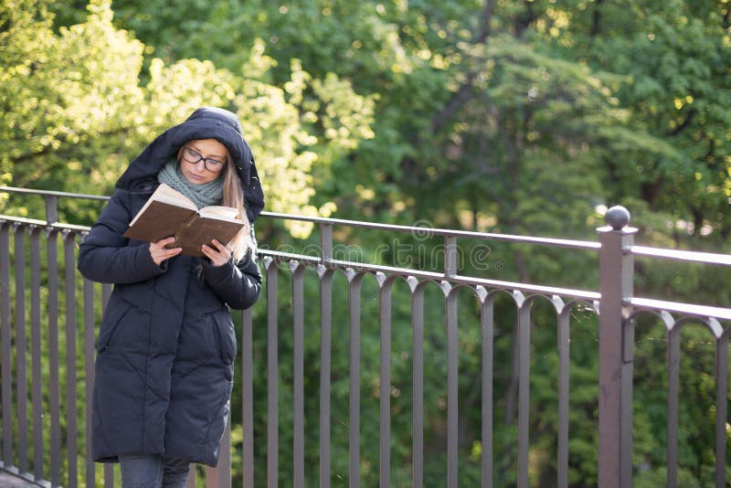 Happy Girl Reading a Book at the Railing. Stock Image - Image of ...