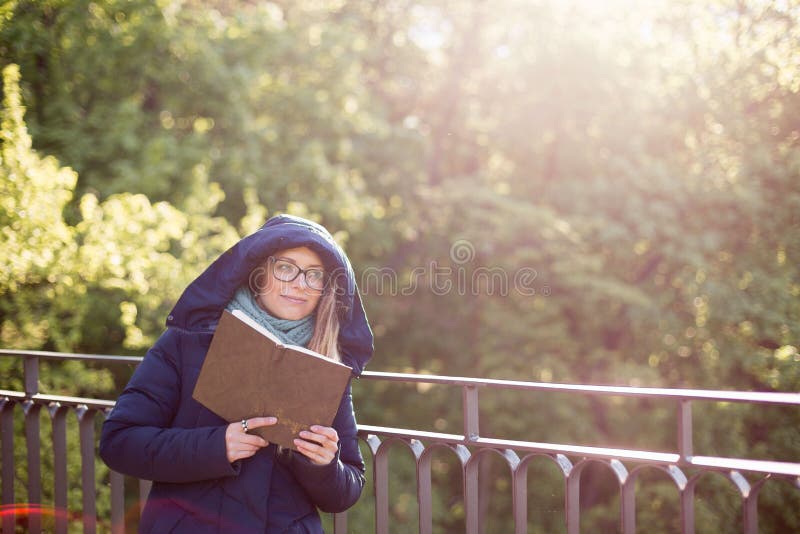 Happy Girl Reading a Book at the Railing. Stock Image - Image of ...