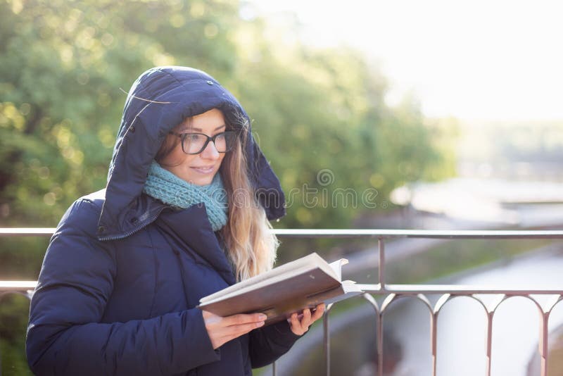 Happy Girl Reading a Book at the Railing. Stock Image - Image of ...