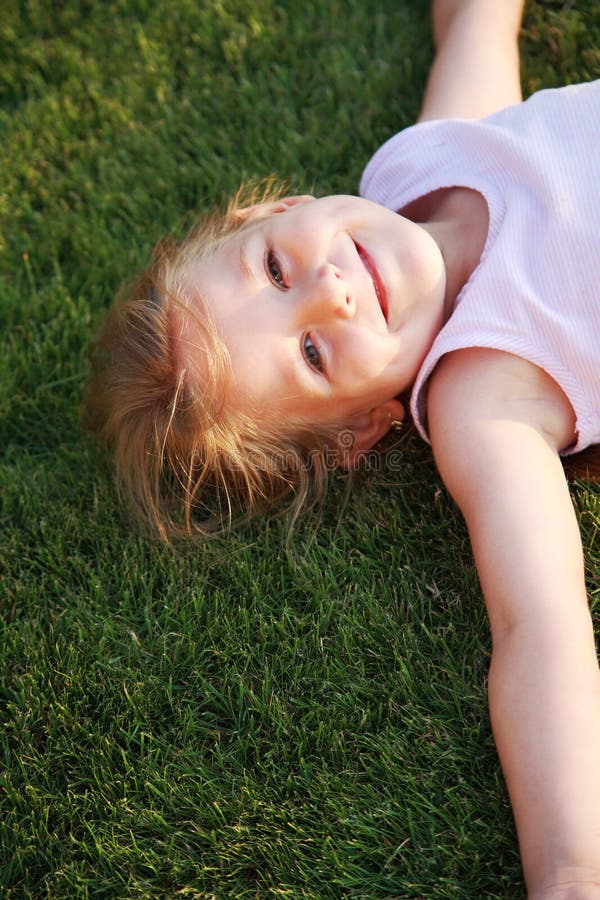Happy Girl Relaxing on a Grass Stock Photo - Image of garden ...