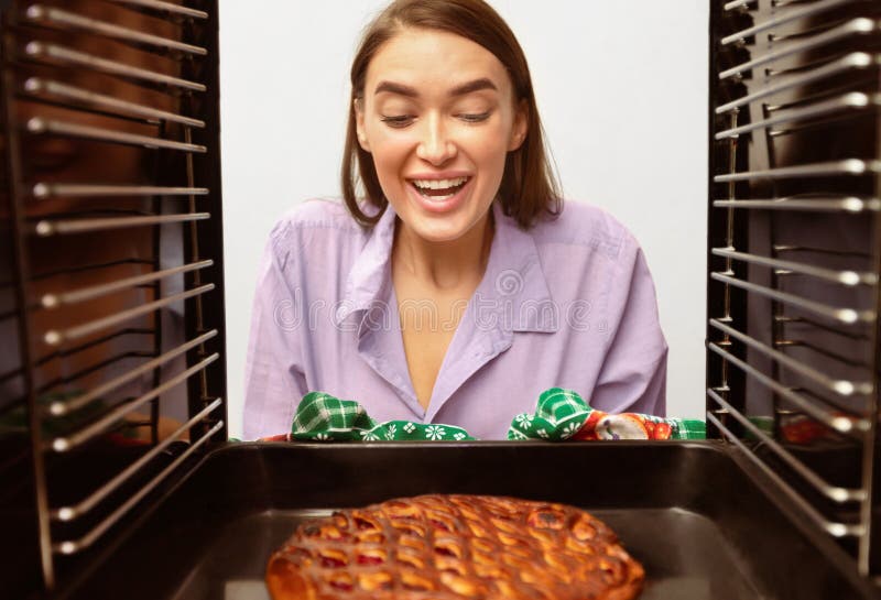 Happy Girl Removing Handmade Pie from Oven, View from Inside Stock ...