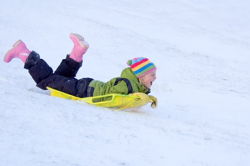 Girl sledding down a hill stock image. Image of sled - 42977865