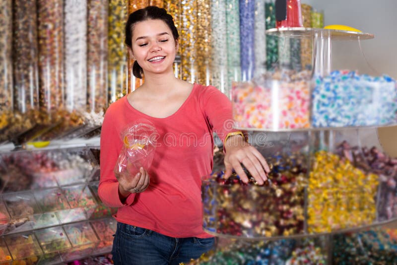 Happy Girl in Store is Picking Up Candies Stock Photo - Image of series ...