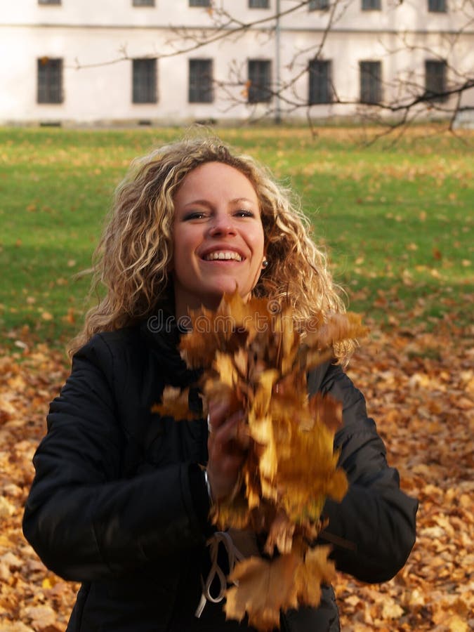 Happy Girl Throwing Maple Leaves Stock Photo - Image of colored, smile ...