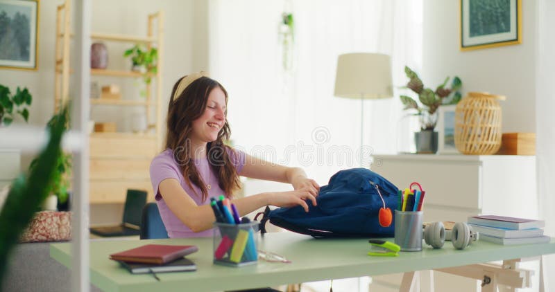 Happy Girl Unpacks Her School Backpack at the Desk Stock Footage ...