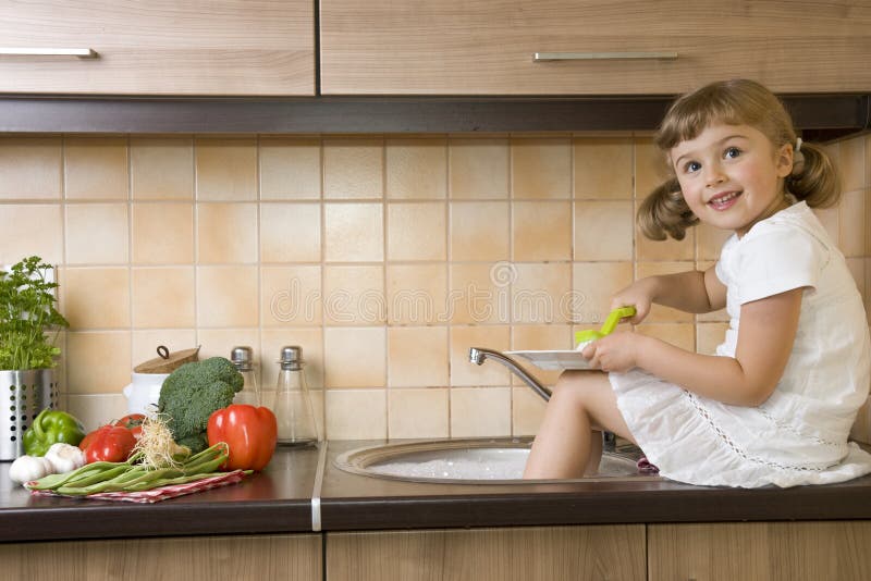 Happy girl washing dishes stock image. Image of plates - 7130505