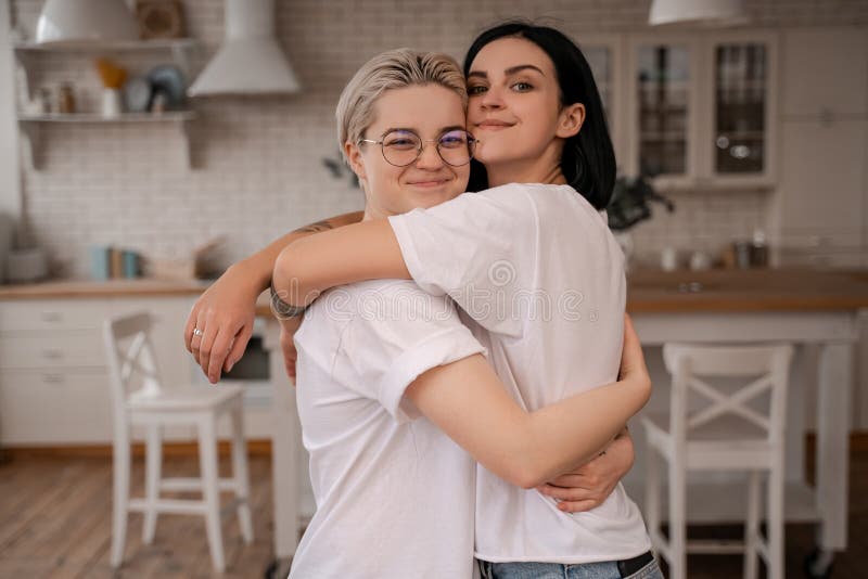 Happy Girlfriends Hugging and Looking at Stock Image - Image of home ...