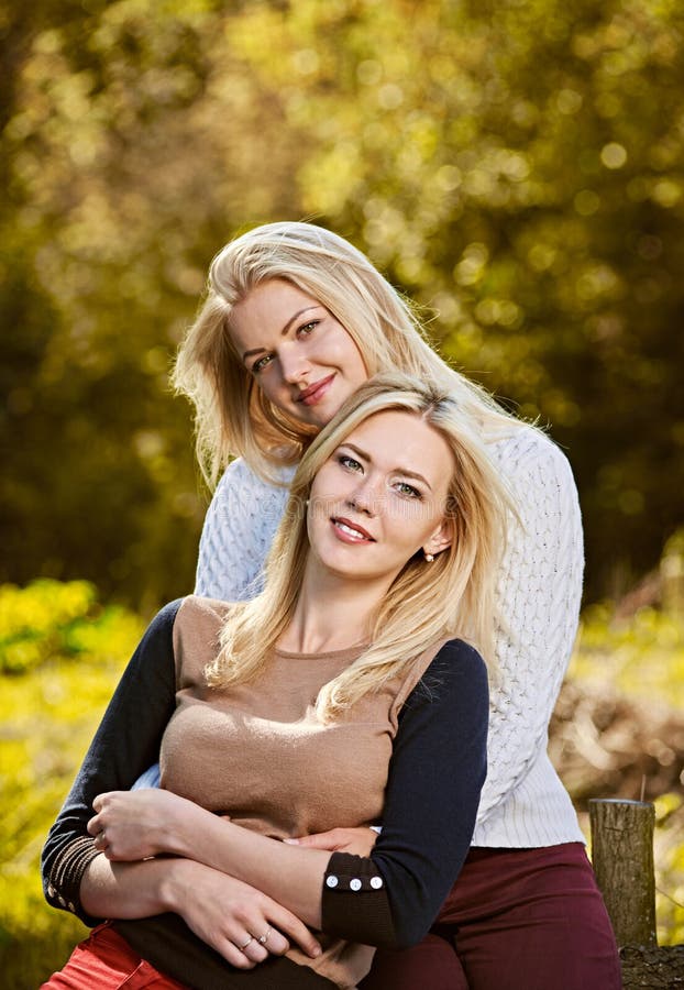 Happy girlfriends hugging stock photo. Image of lifestyle - 98460700