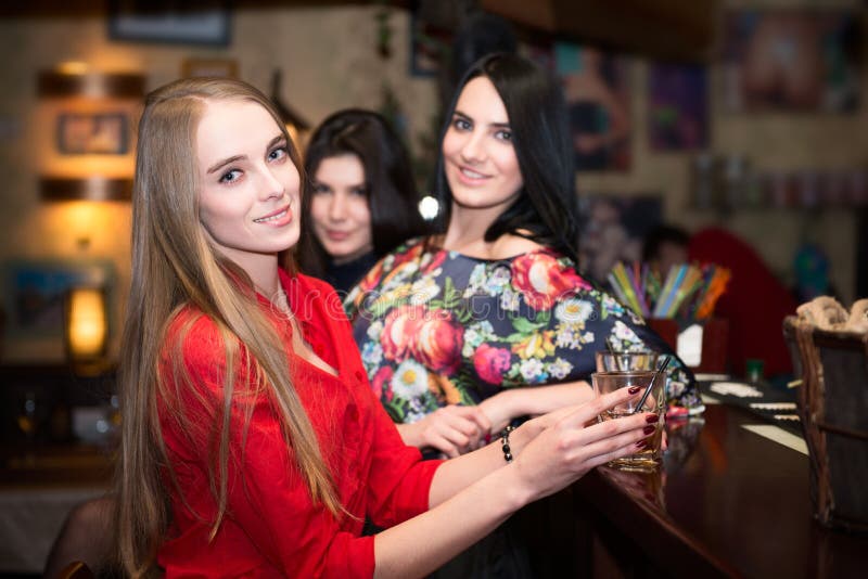 Happy Girlfriends Sitting at the Bar with Cocktails Stock Image - Image ...