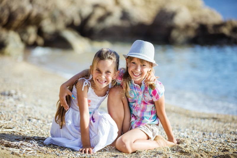 Happy girls on the beach stock image. Image of looking - 82278505