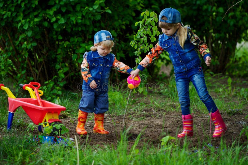Happy girls planting tree stock image. Image of life - 72103167