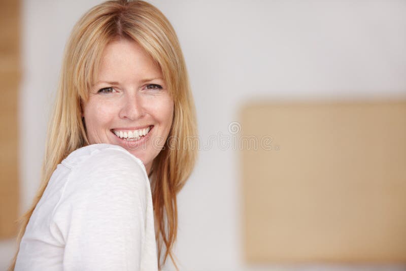 Happy Go Lucky Attitude A Beautiful Mature Woman Smiling At The Camera
