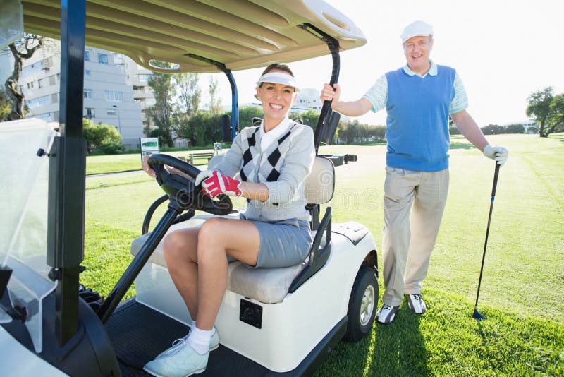 Happy Golfing Couple Setting Out for the Day on Buggy Stock Photo ...